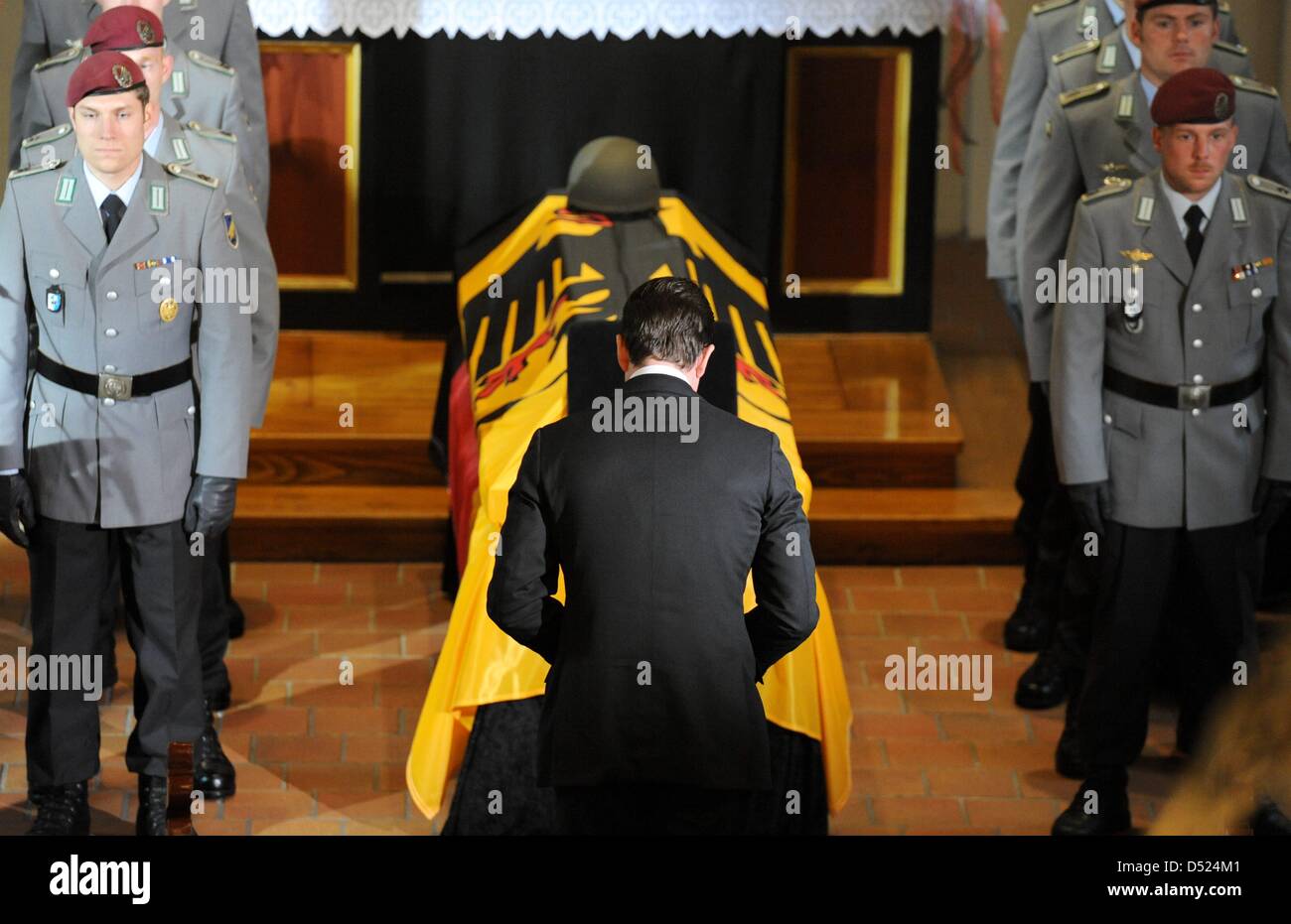 German Defence Minister Karl-Theodor zu Guttenberg pays his respects at ...