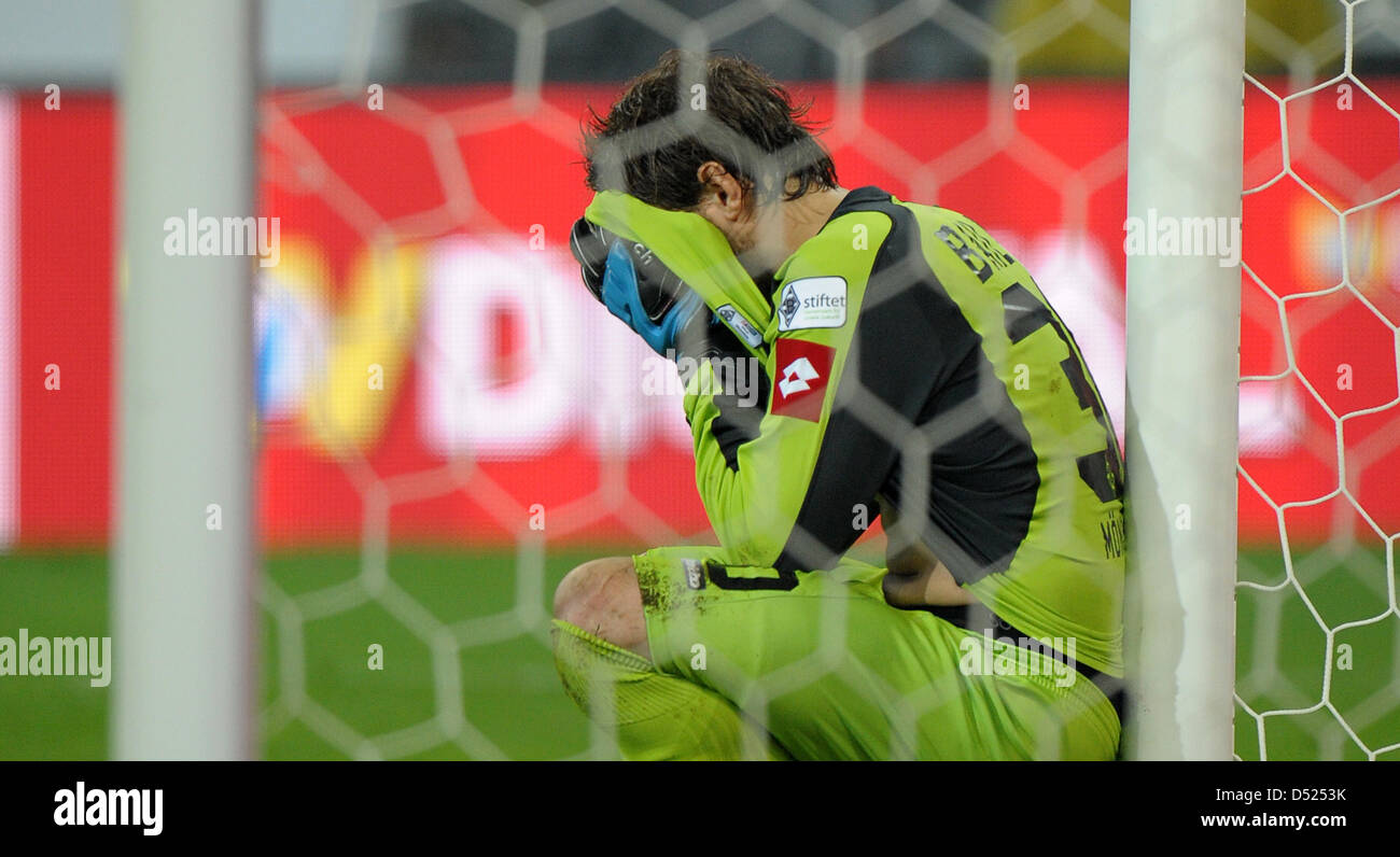 Gladbach's goalkeeper Logan Bailly covers his face, due to ...