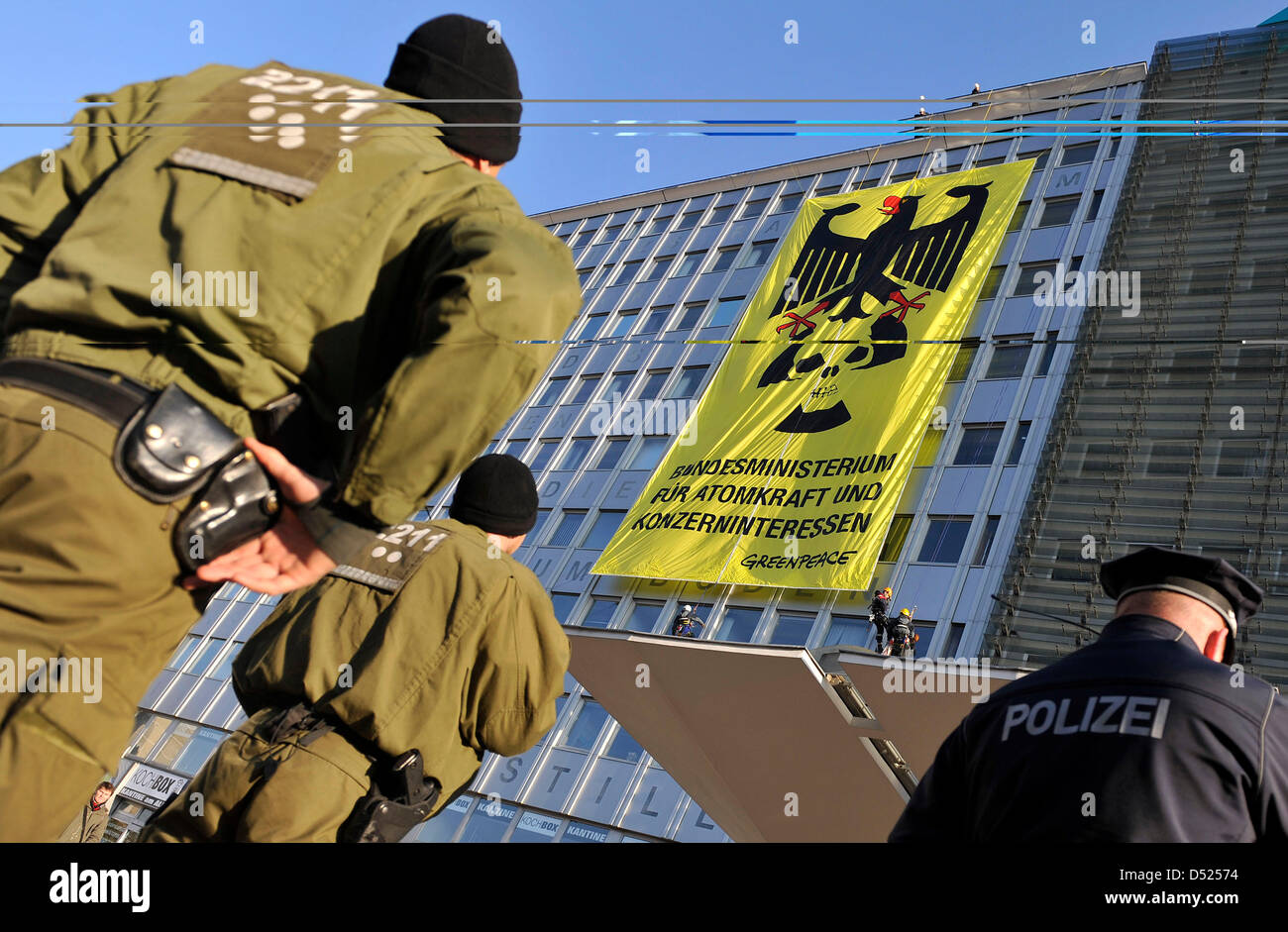 Policemen watch a banner reading 'Federal Ministry for nuclear energy ...