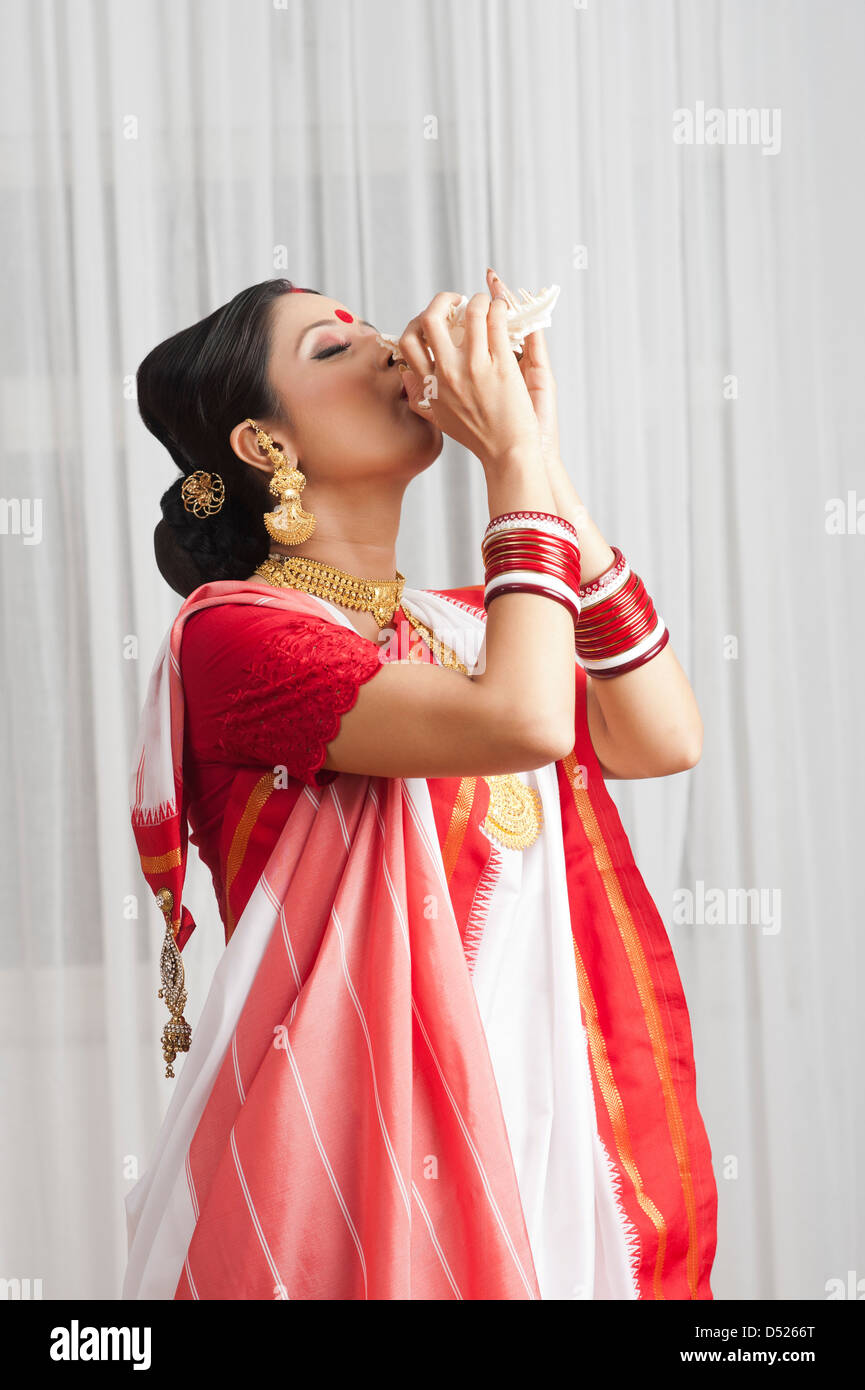 Blowing conch shell hi-res stock photography and images - Alamy