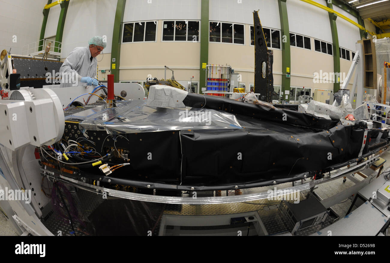 An employee of the satellite manufacturer Astrium works on one of the ...