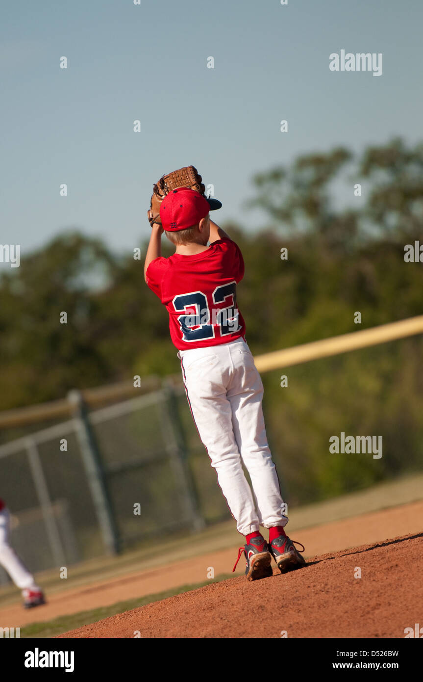 Young little league baseball pitcher checking second base runner Stock ...