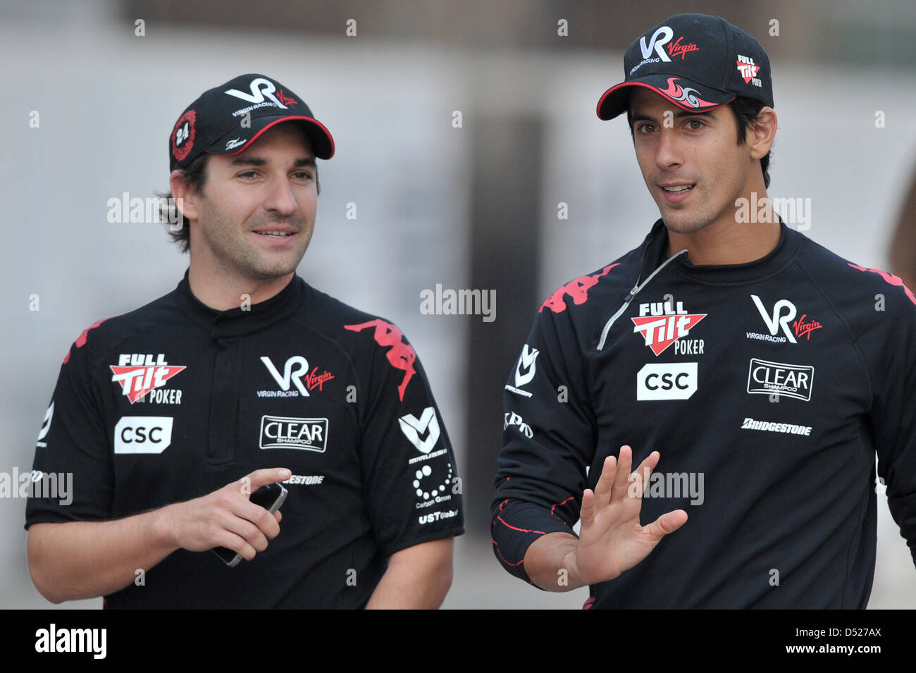 The German Formula One driver Timo Glock (L) of Virgin Racing smiles ...