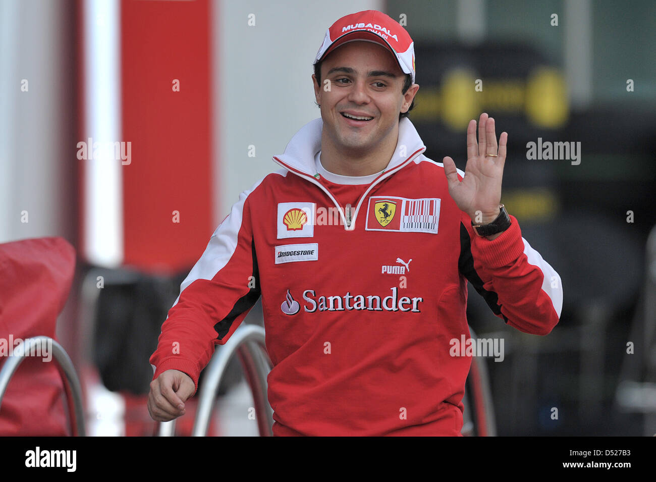 The Brasilian driver Mark Webber of Ferrari smiles and waves during a ...