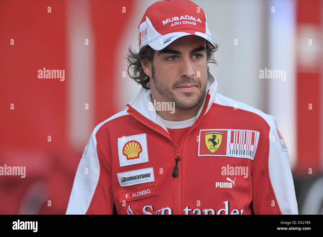 The Spanish driver Fernando Alonso of Ferrari walks through the paddock ...