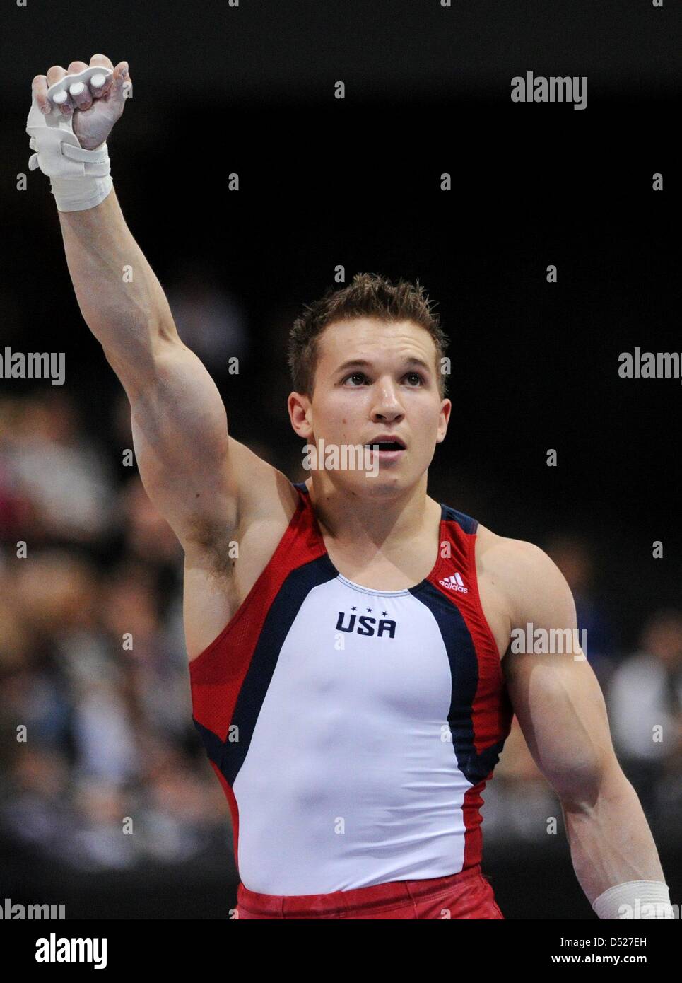 Gymnast Honathan Horton from the USA raises his arm after an exercise ...