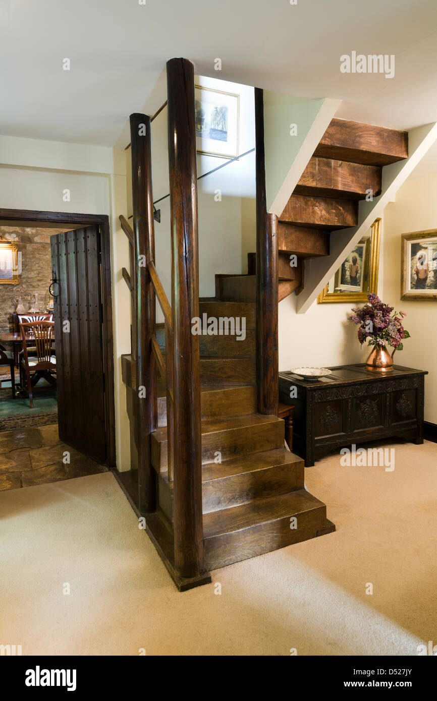 An arts and crafts style staircase in a cottage entrance hall Stock ...