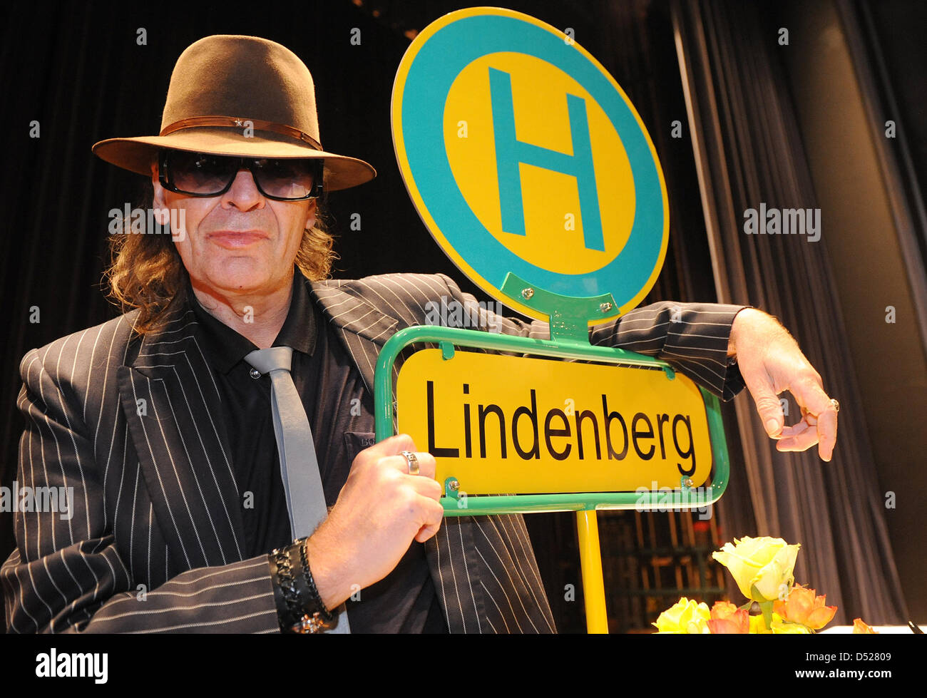 German musician Udo Lindenberg holds a bus stop sign with the caption ...