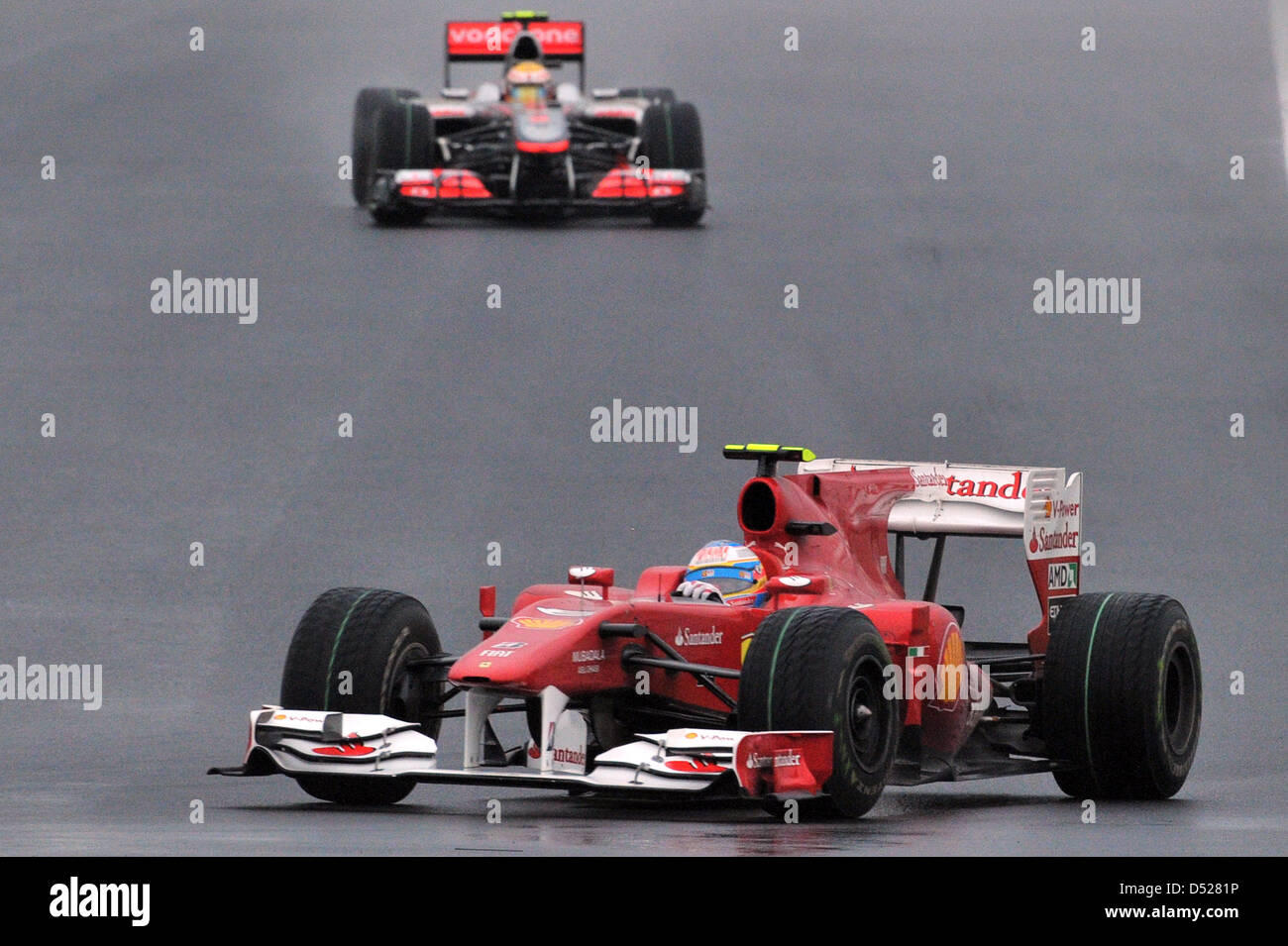 Spanish driver Fernando Alonso of Ferrari crosses the finish line ...