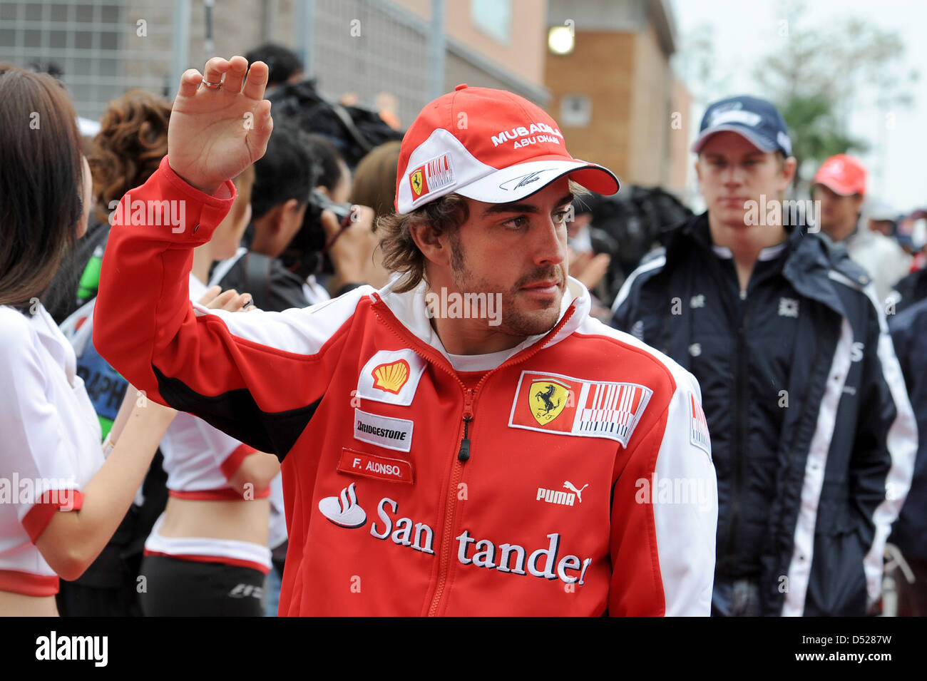 Spanish driver Fernando Alonso of Ferrari waves to the crowd at the ...