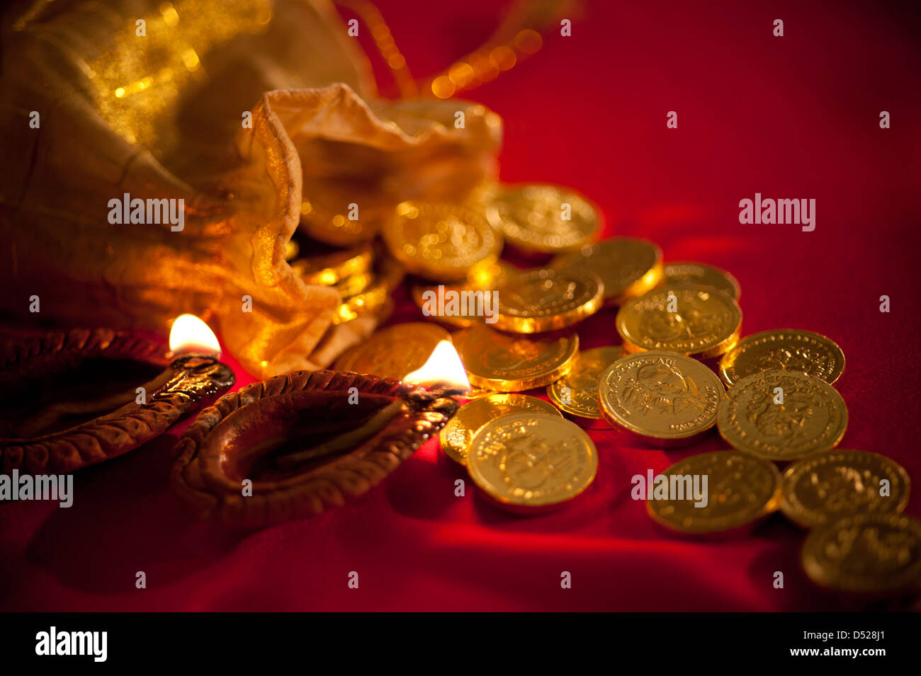 Diwali oil lamps with golden coins during Diwali festival Stock Photo ...