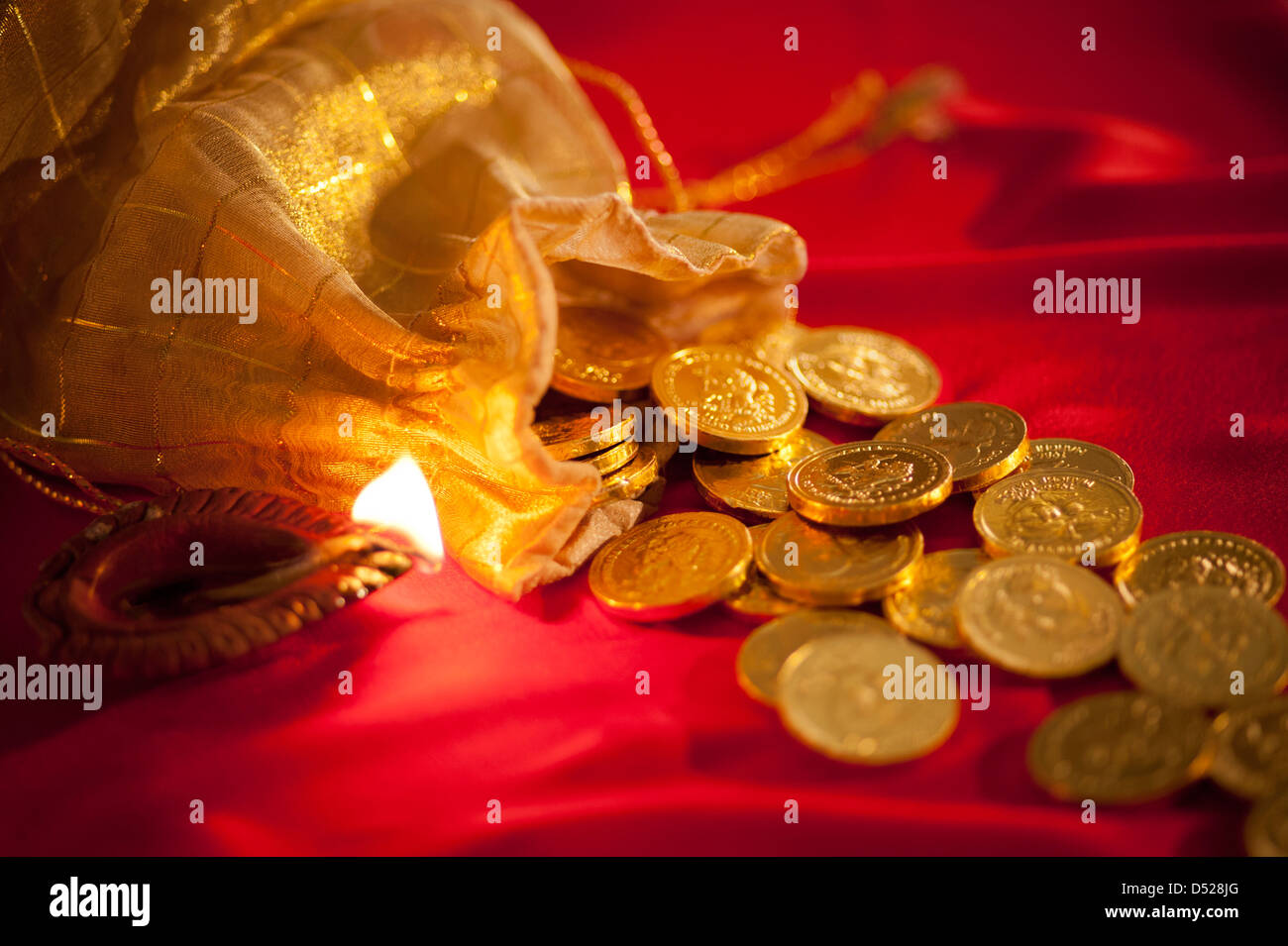 Diwali oil lamp with golden coins during Diwali festival Stock Photo ...