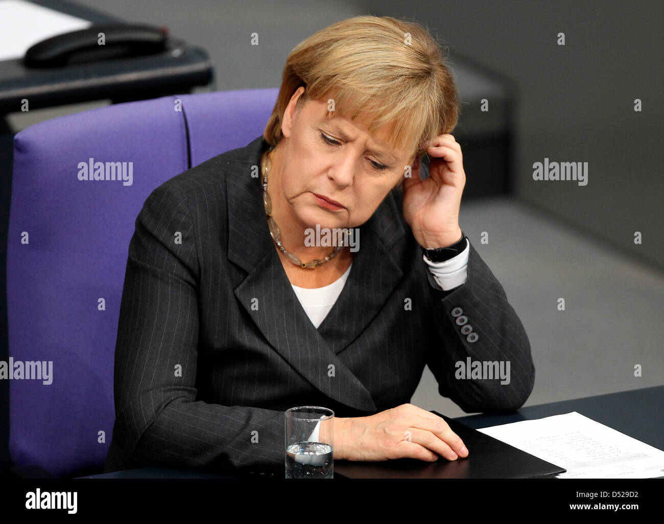 German Chancellor Angela Merkel follows a debate at the Bundestag in ...