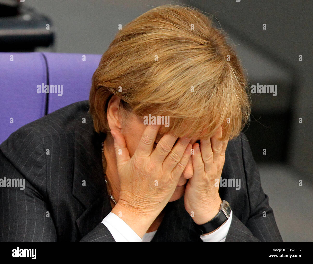 German Chancellor Angela Merkel seems tired as she follows a debate at ...