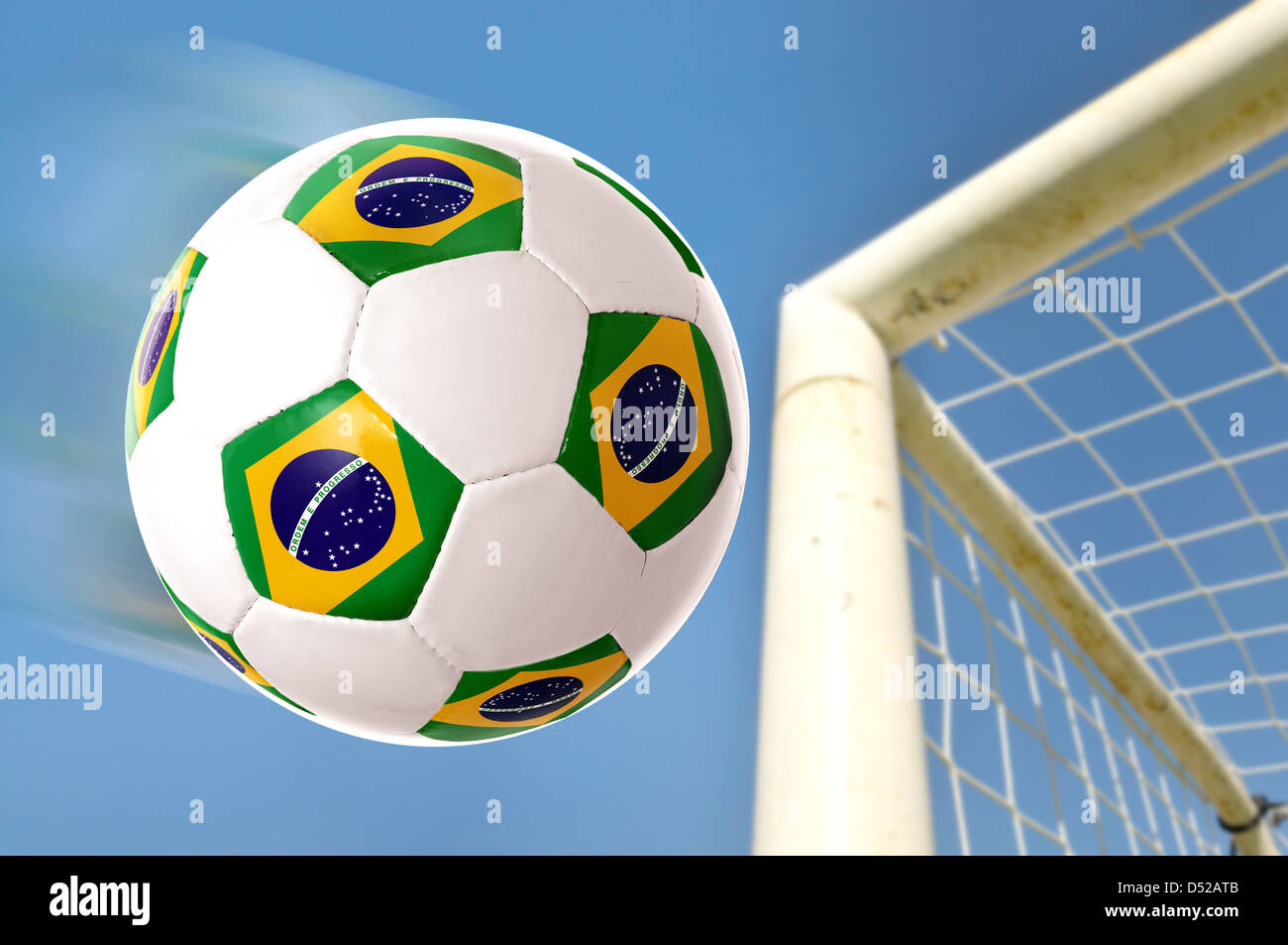Brazilian flag soccer ball over a goal's net Stock Photo - Alamy