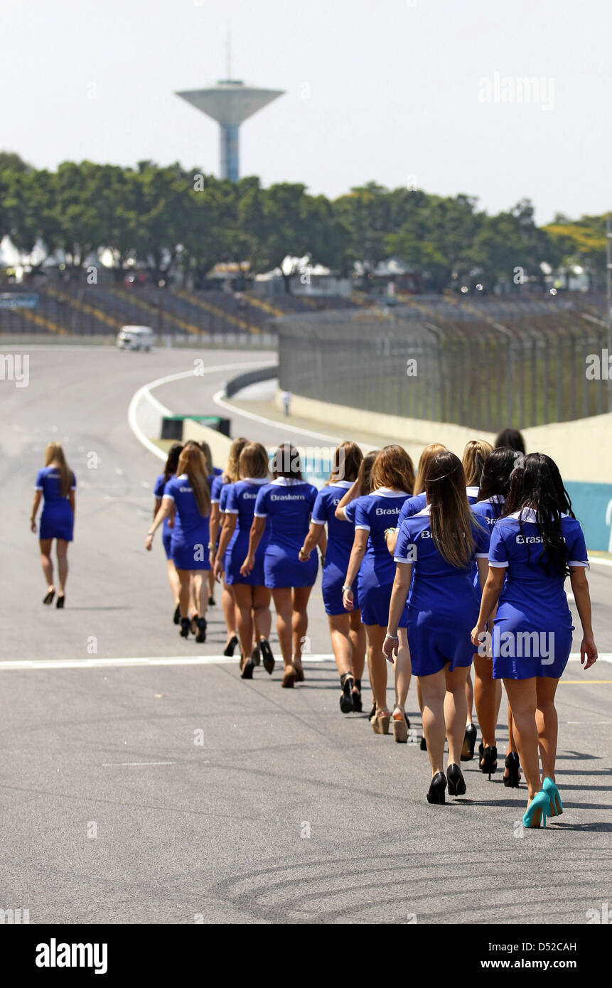 Grid girls walk along the race track during an instruction for the ...