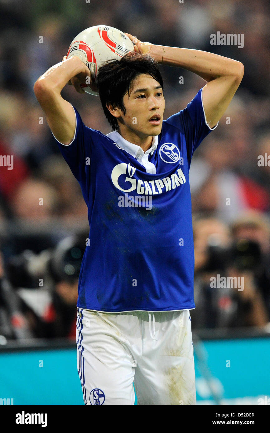 Schalke's Atsuto Uchida performs a throw-in during German Bundesliga ...