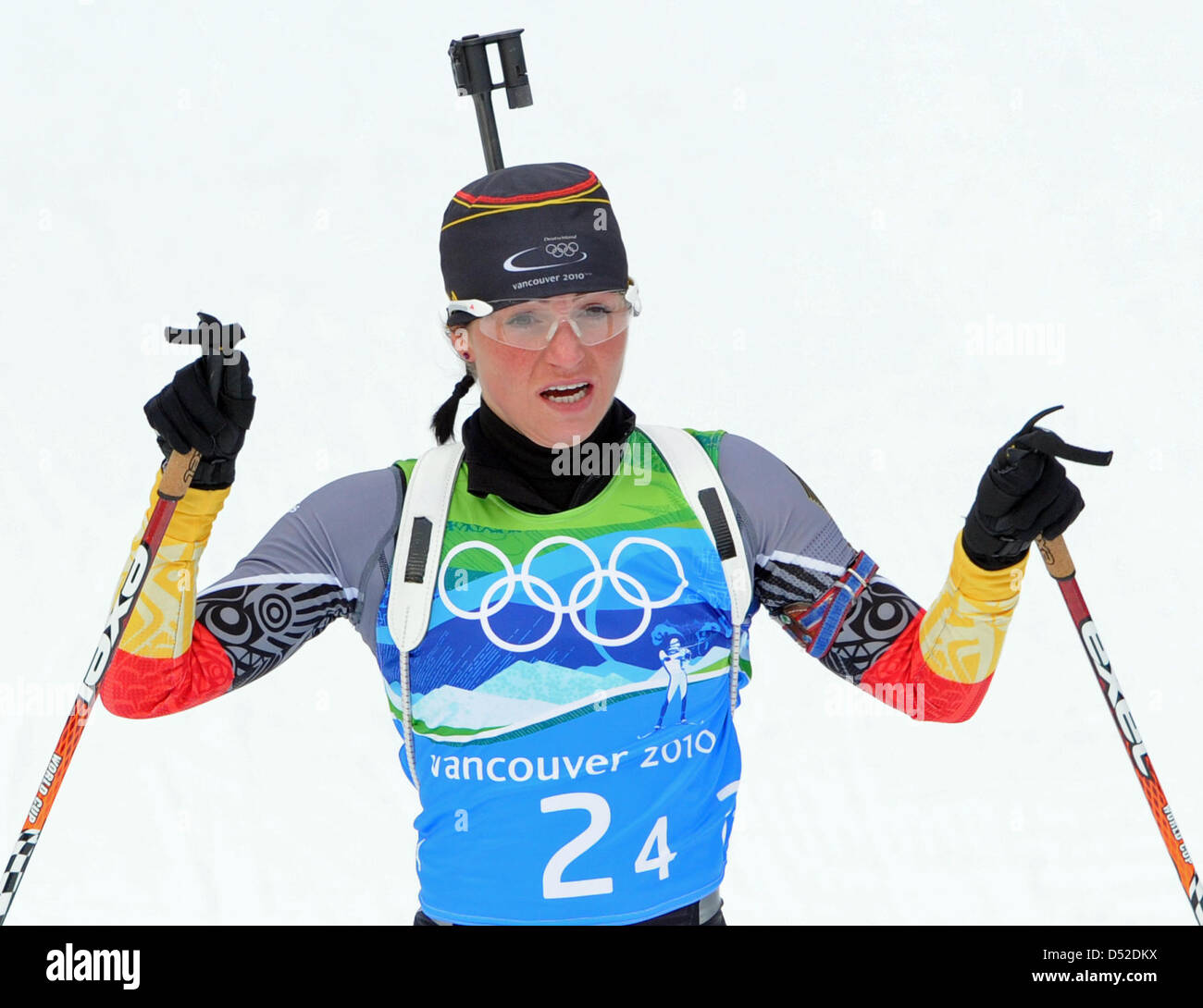 Andrea Henkel of Germany reacts after crossing the finish line during ...