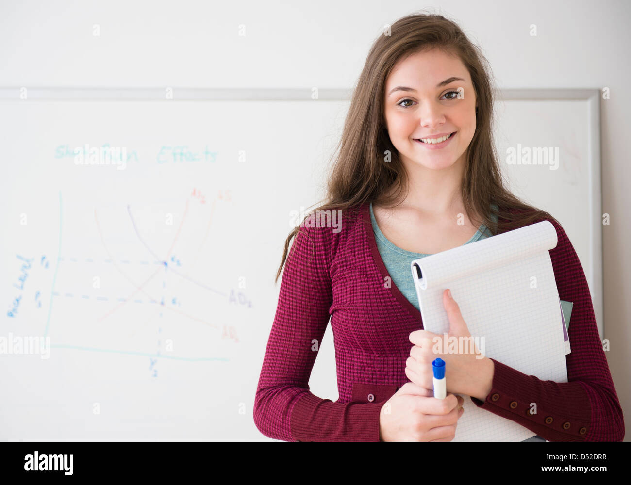 Hispanic girl holding notepad Stock Photo - Alamy