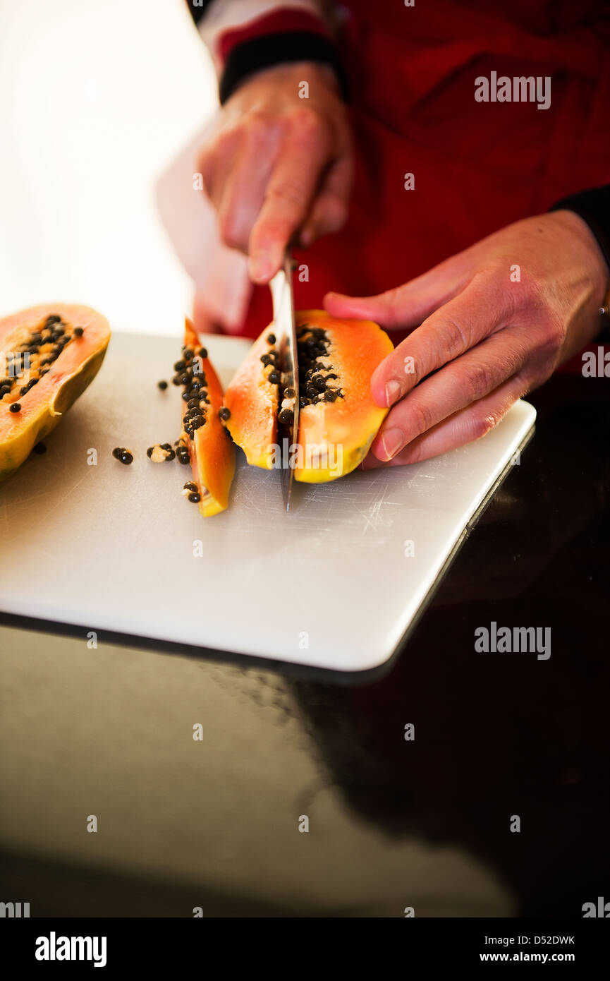Chopping a papaya Stock Photo - Alamy
