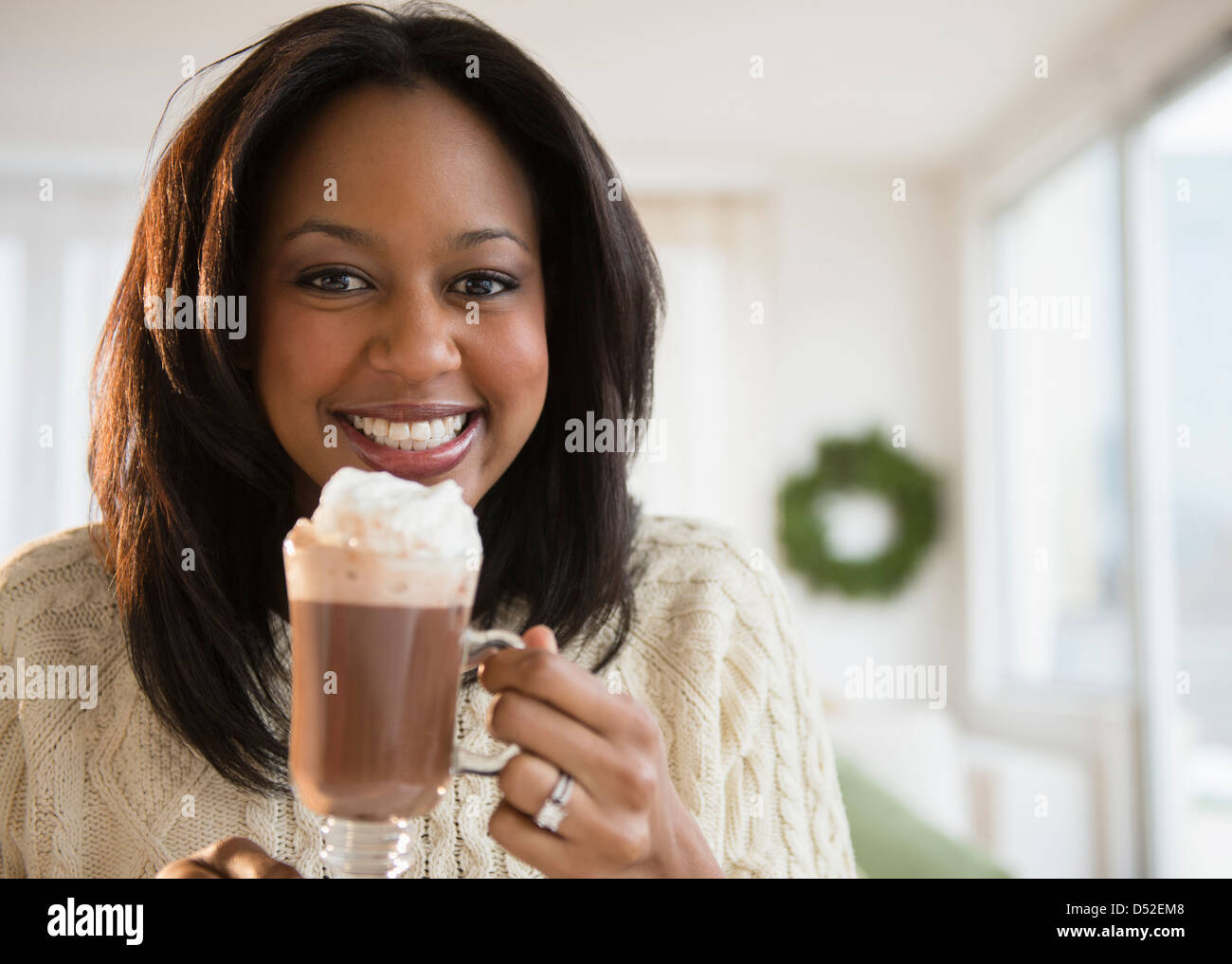 African American woman drinking hot chocolate Stock Photo - Alamy