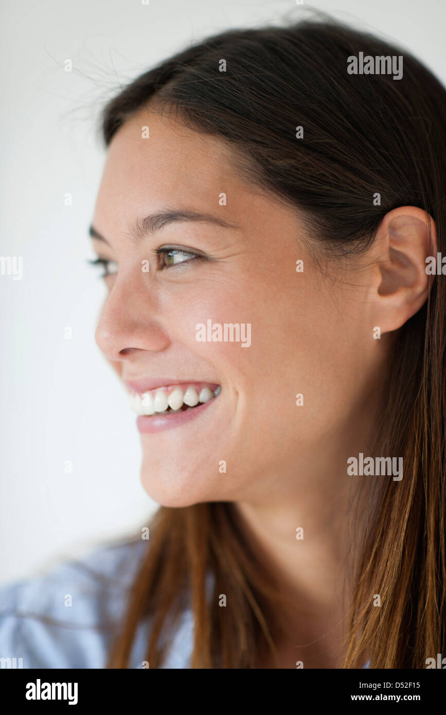Young woman smiling, profile Stock Photo - Alamy