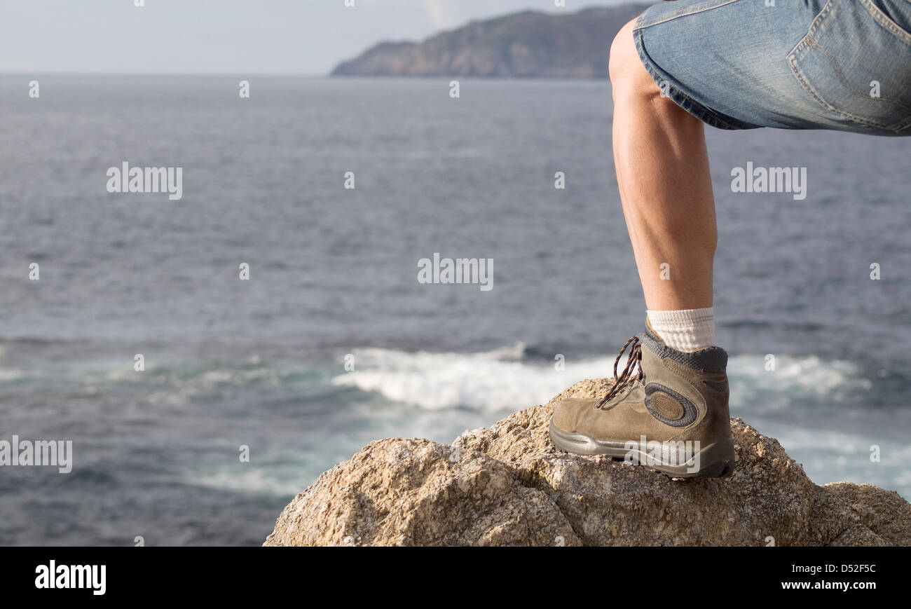 The photo shows a leg on a rock at a seascape Stock Photo - Alamy