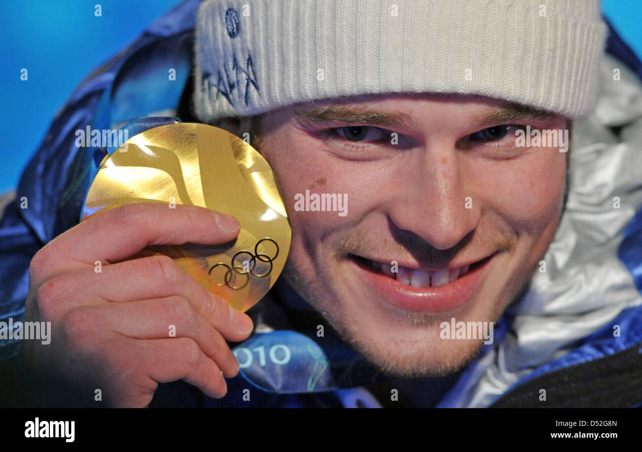 Gold medalist Giuliano Razzoli of Italy kisses his gold medal during ...
