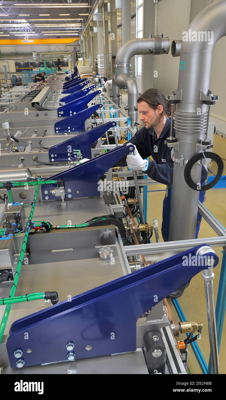 Rene Hoppe of Roth & Rau works on a coating unit for the production of ...