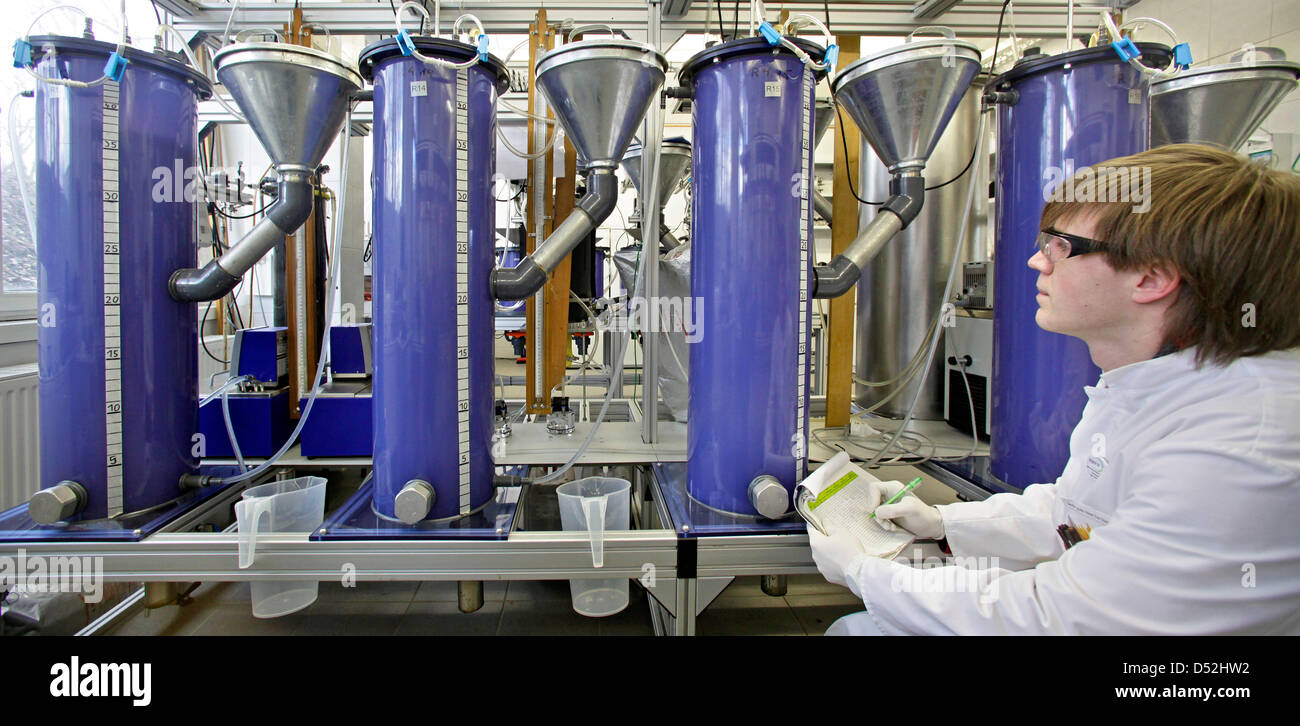 Research assistant Matthias Mueller fuels one of 40 biogas reactors at ...