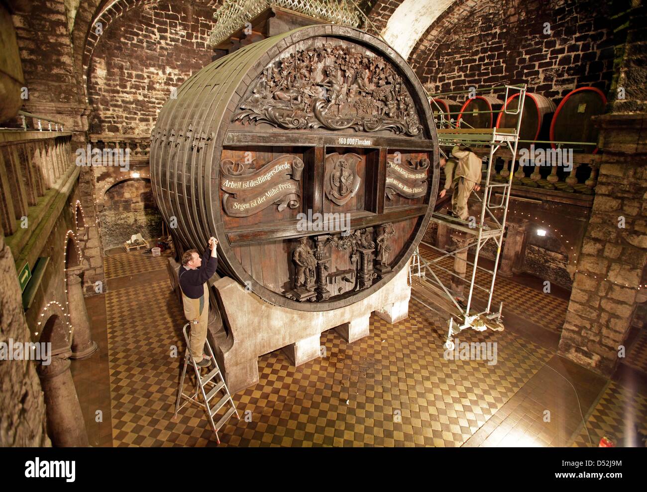 Two men repair agiant barrel of German champagne maker Rotkaeppchen in ...