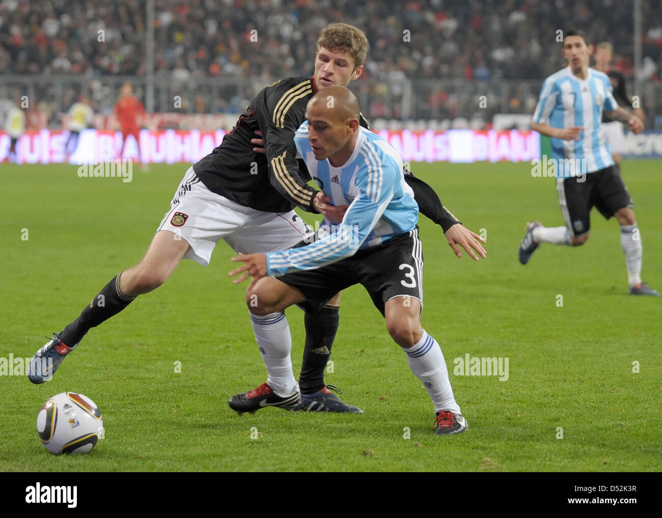 Germany's Thomas Mueller (L) and Argentina's Clemente Rodriguez (R) vie ...