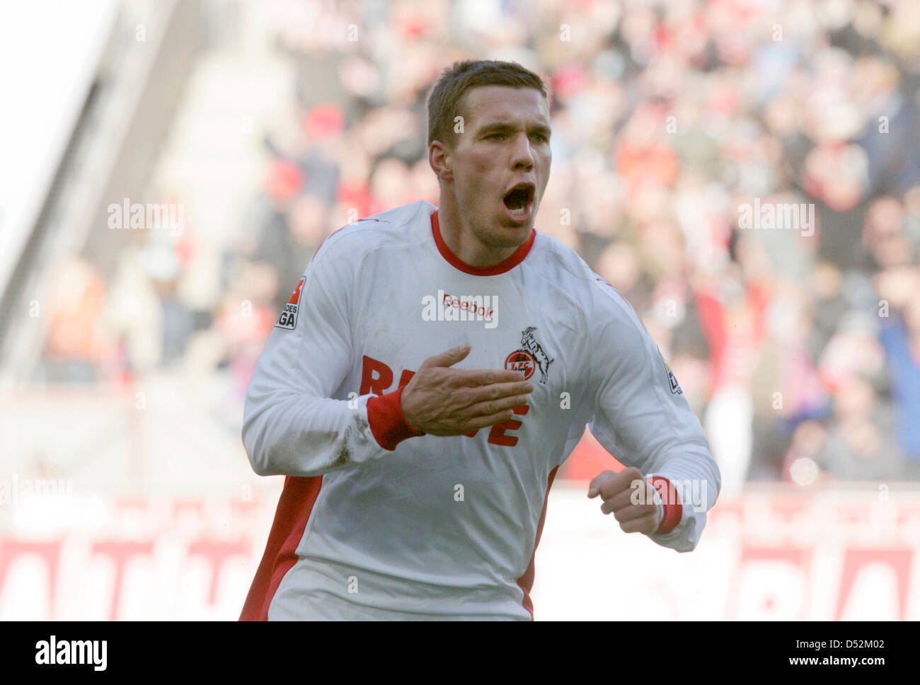 Cologne's Lukas Podolski celebrates his 1-0 during German Bundesliga ...