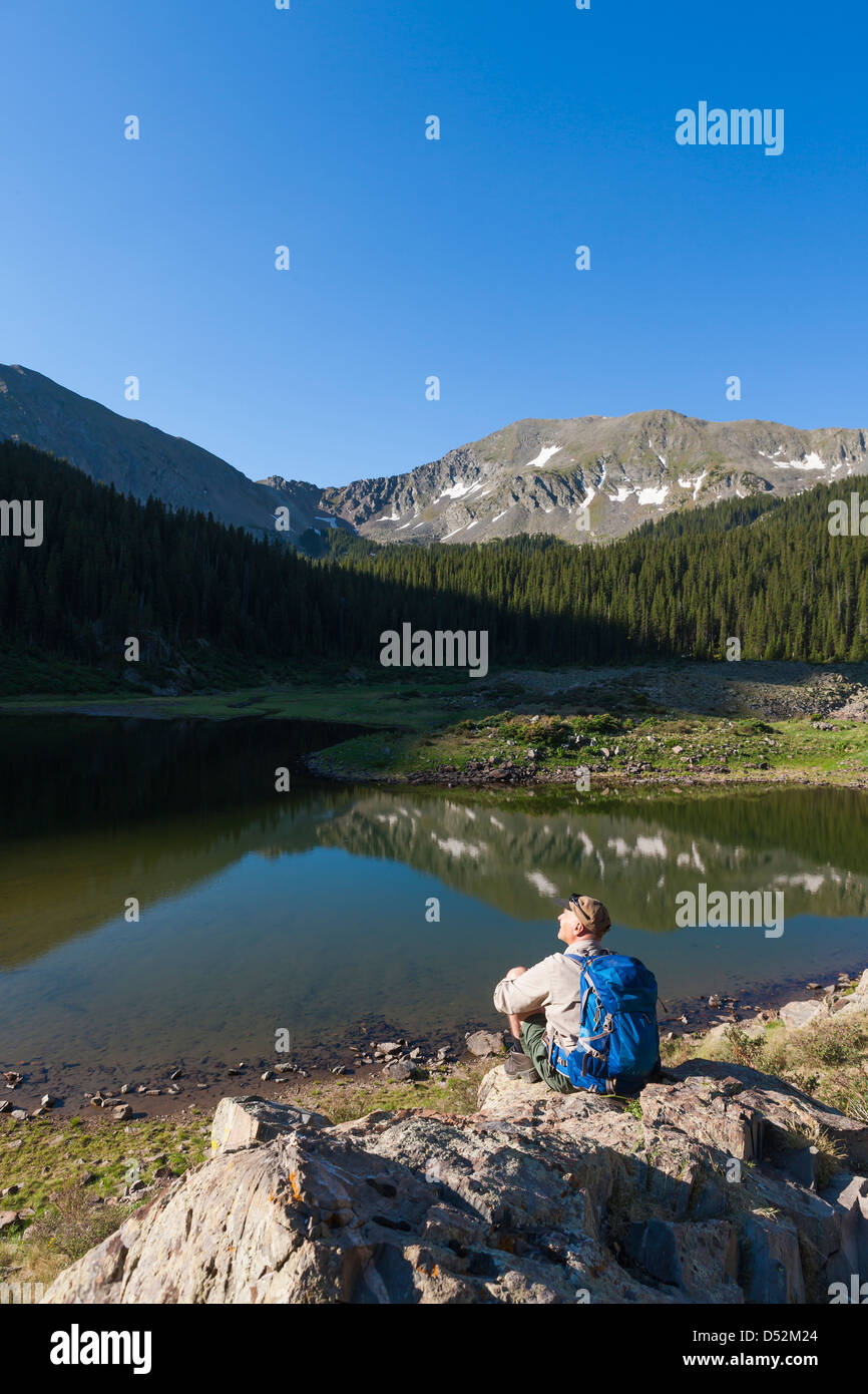 Caucasian hiker sitting on boulder Stock Photo - Alamy
