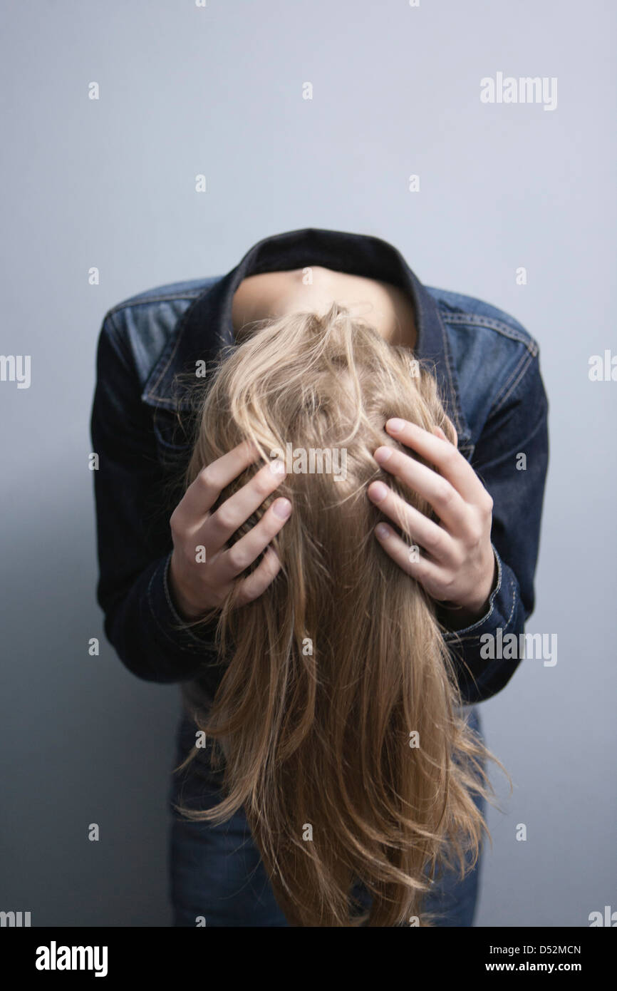 Woman bending over head down hi-res stock photography and images - Alamy