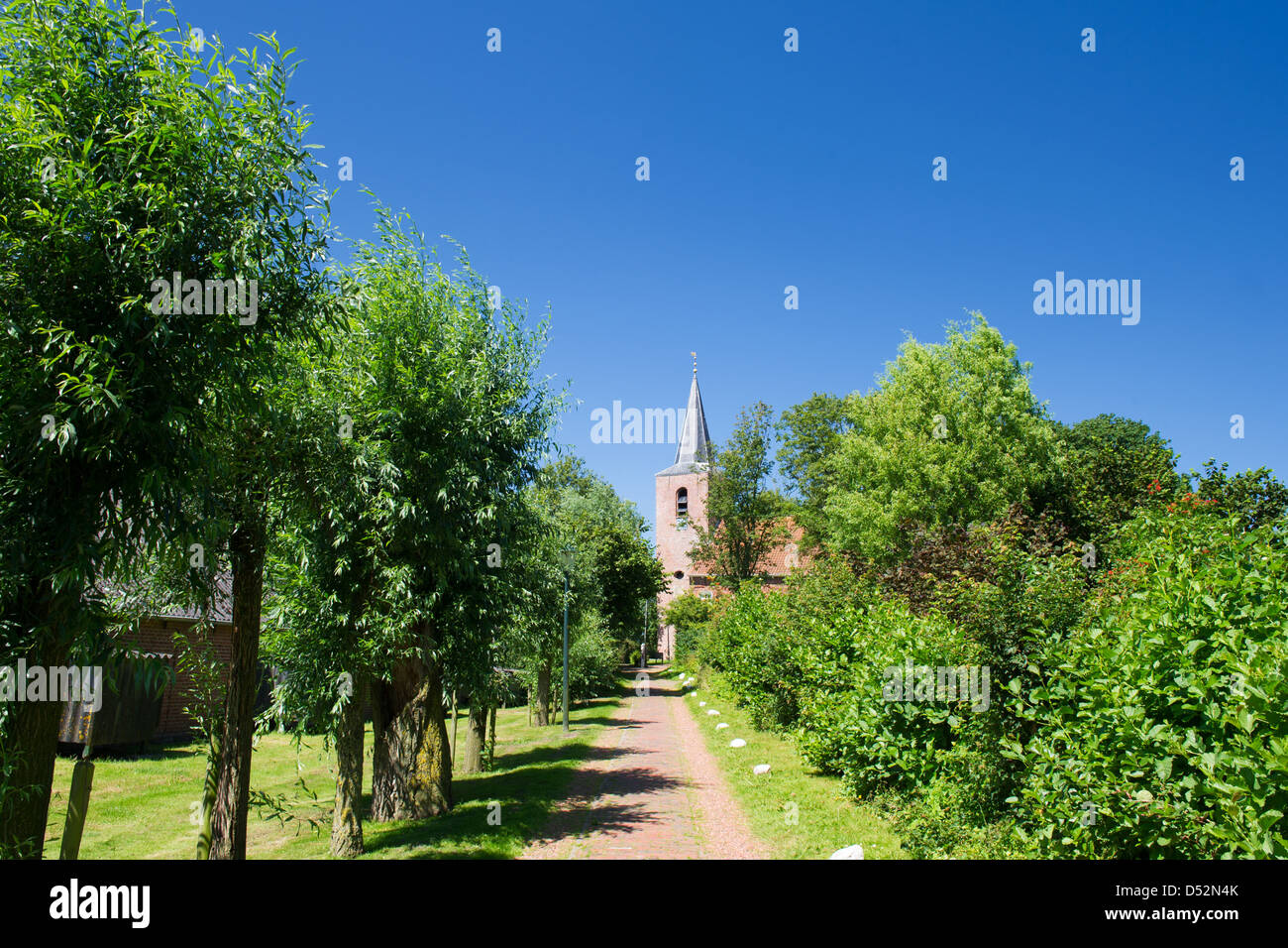 Dutch village with path to the church Stock Photo - Alamy