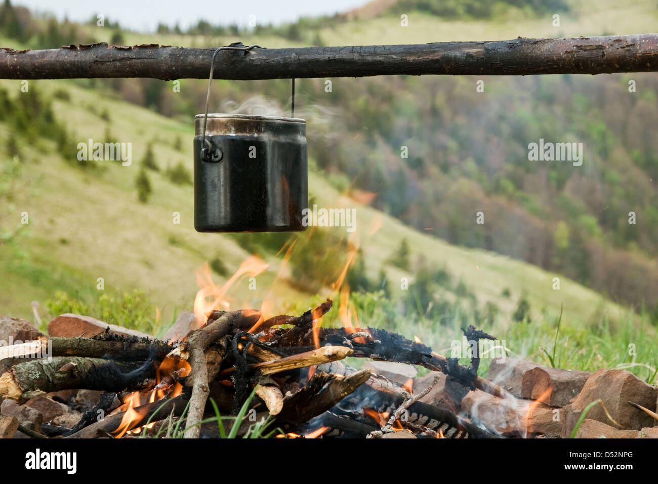 camping pot on fire closeup Stock Photo - Alamy