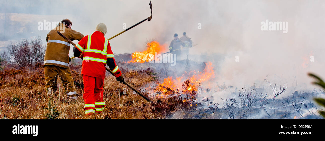 Firemen fight to control a moor hill fire on the west coast of Scotland ...