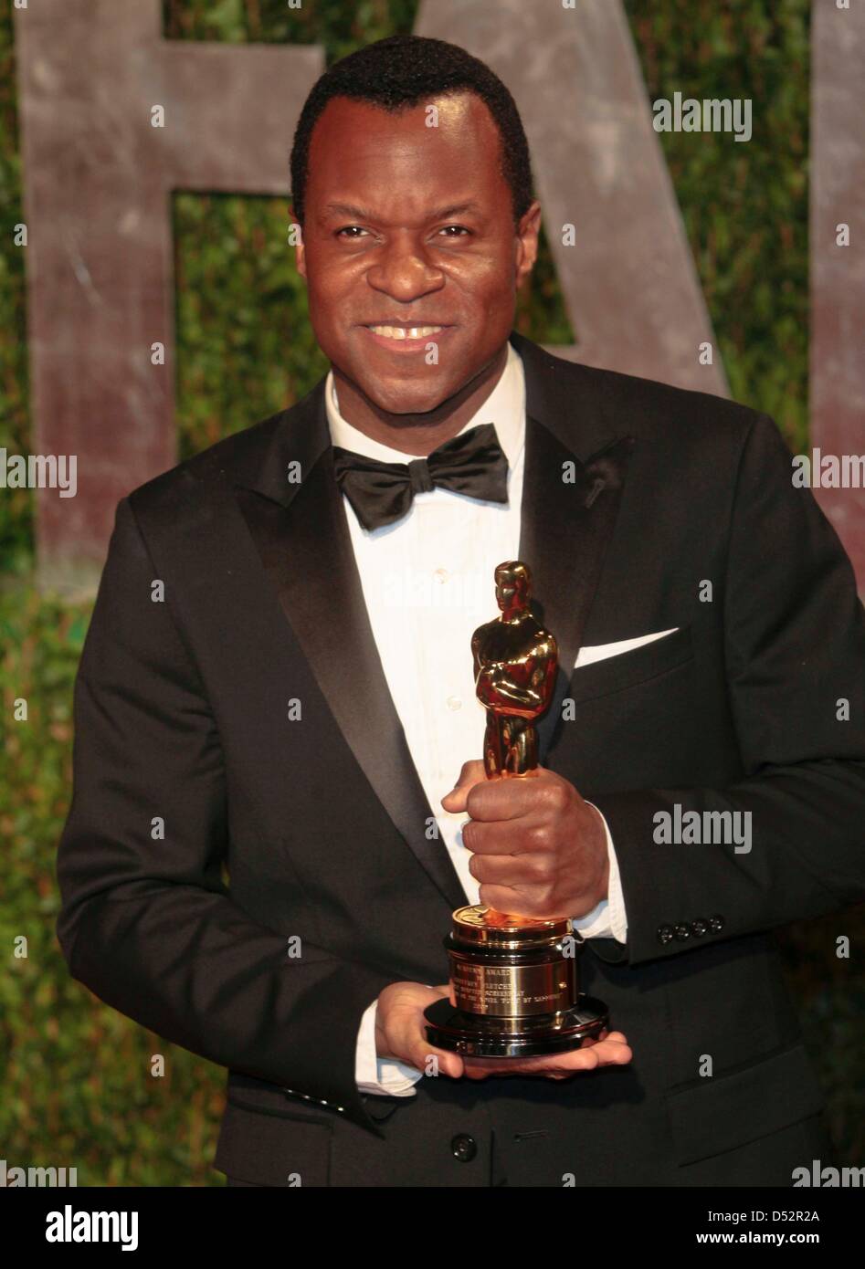 US filmmaker Geoffrey Fletcher holds up his Oscar Award as he arrives ...