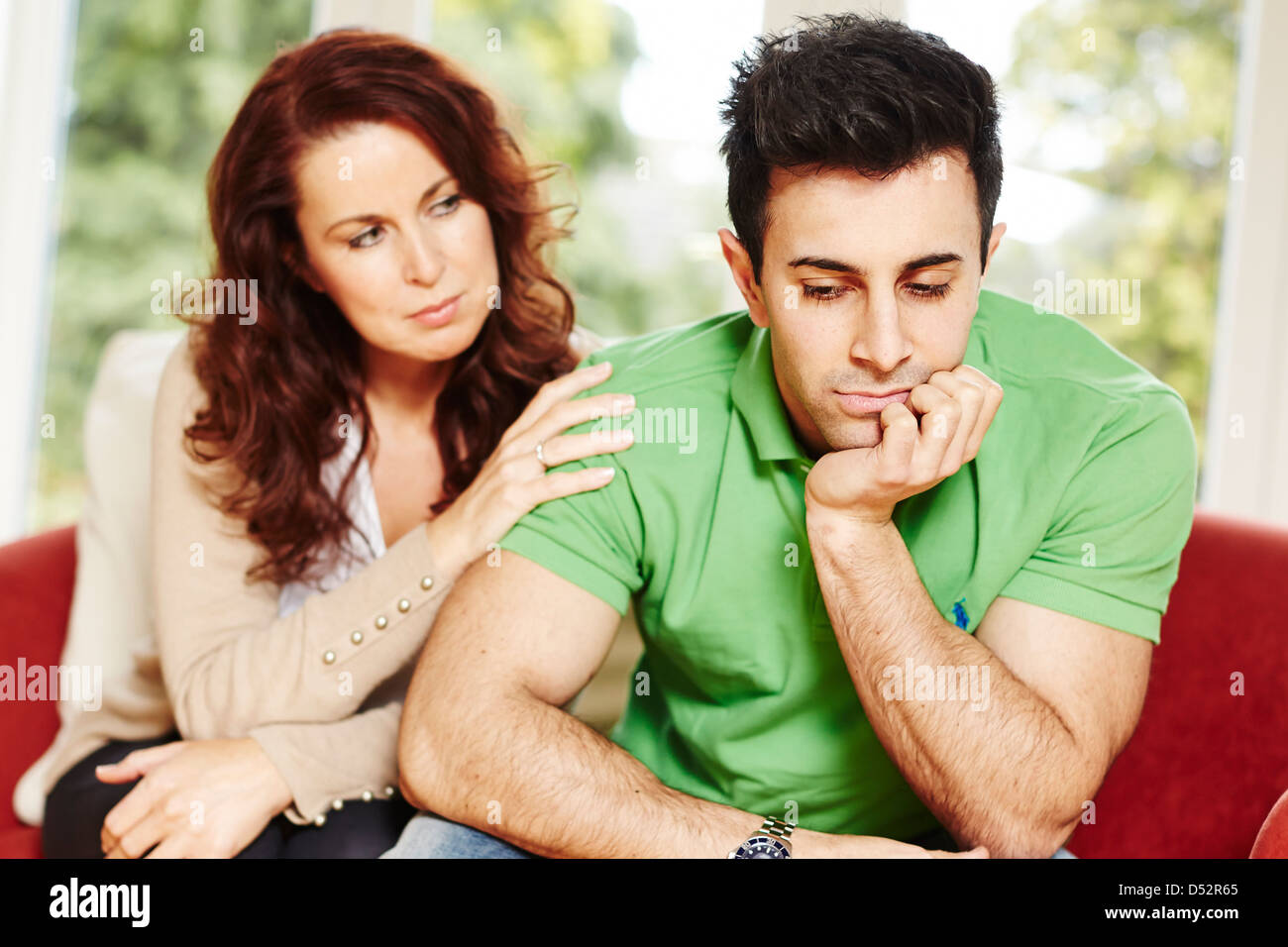 Man consoling her on sofa at home hi-res stock photography and images ...