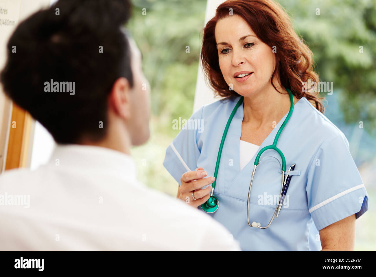 Nurse talking to patient Stock Photo - Alamy