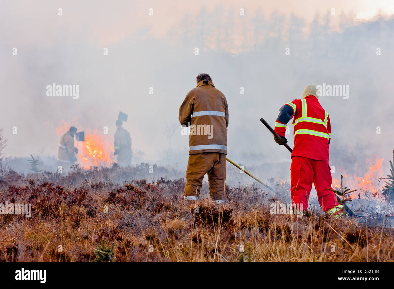Firemen fight to control a moor hill fire on the west coast of Scotland ...