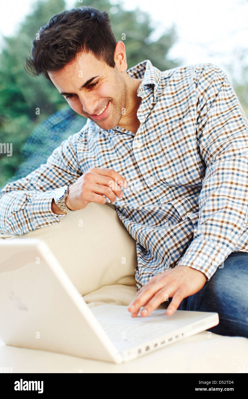 Man relaxing using laptop Stock Photo - Alamy