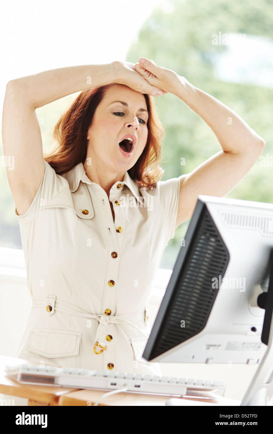 Tired woman yawning Stock Photo - Alamy