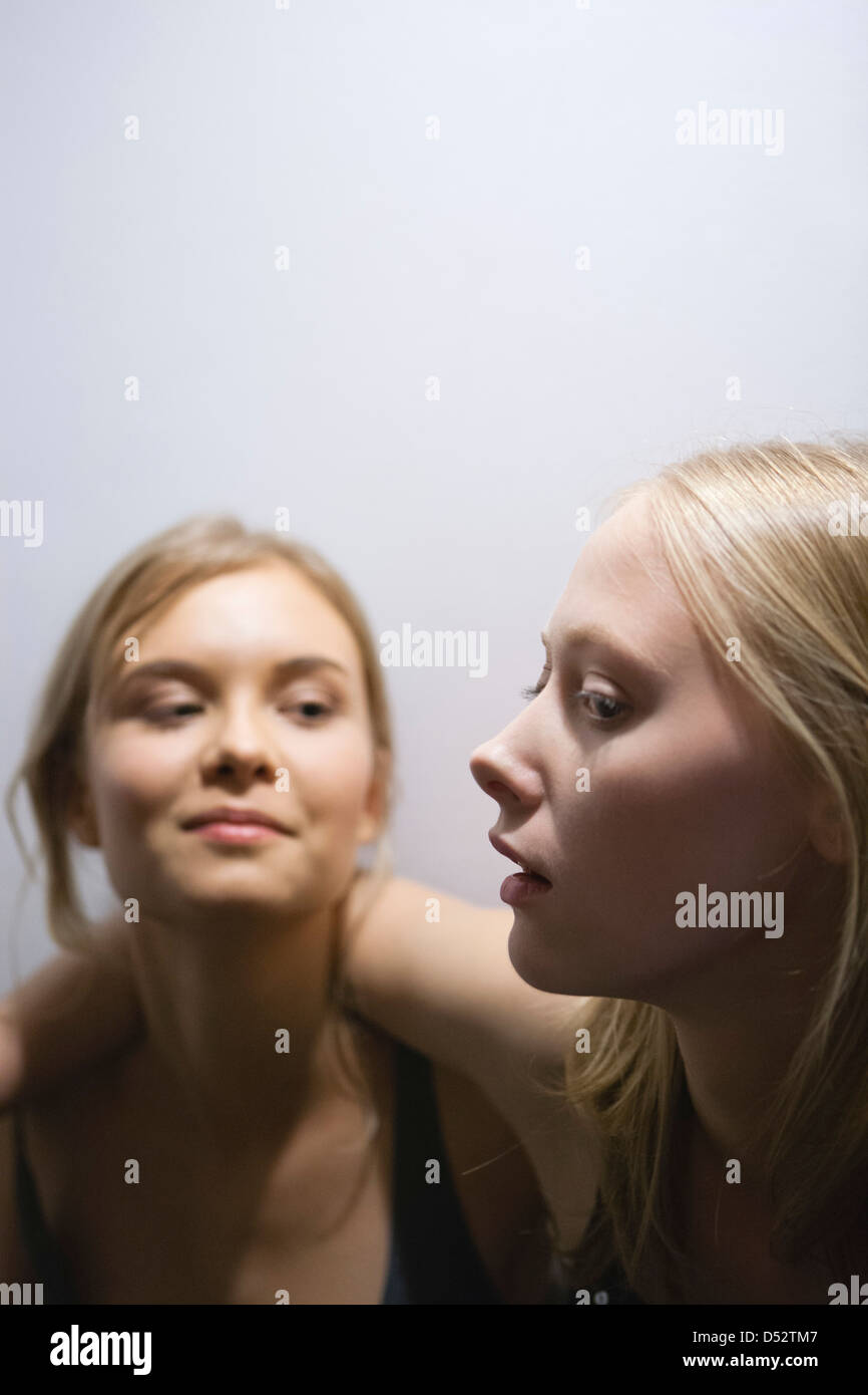 Young woman with arm around friend's shoulder Stock Photo - Alamy