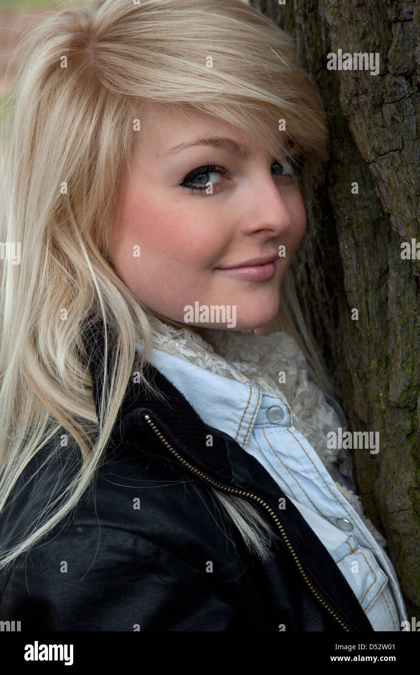 Pretty girl beside a tree Stock Photo - Alamy