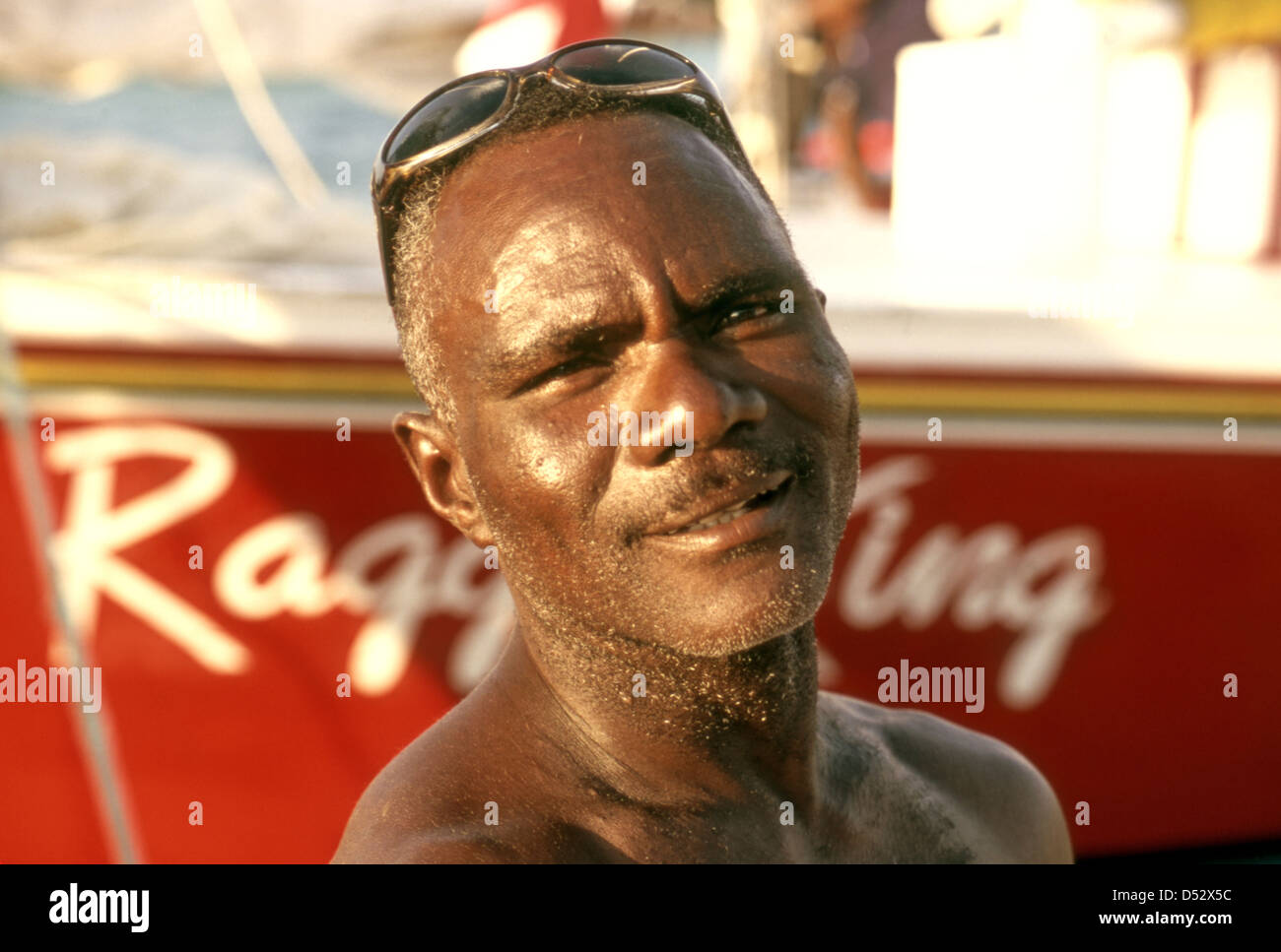 Portrait of a smiling Creole man offering sailing charters on Caye ...