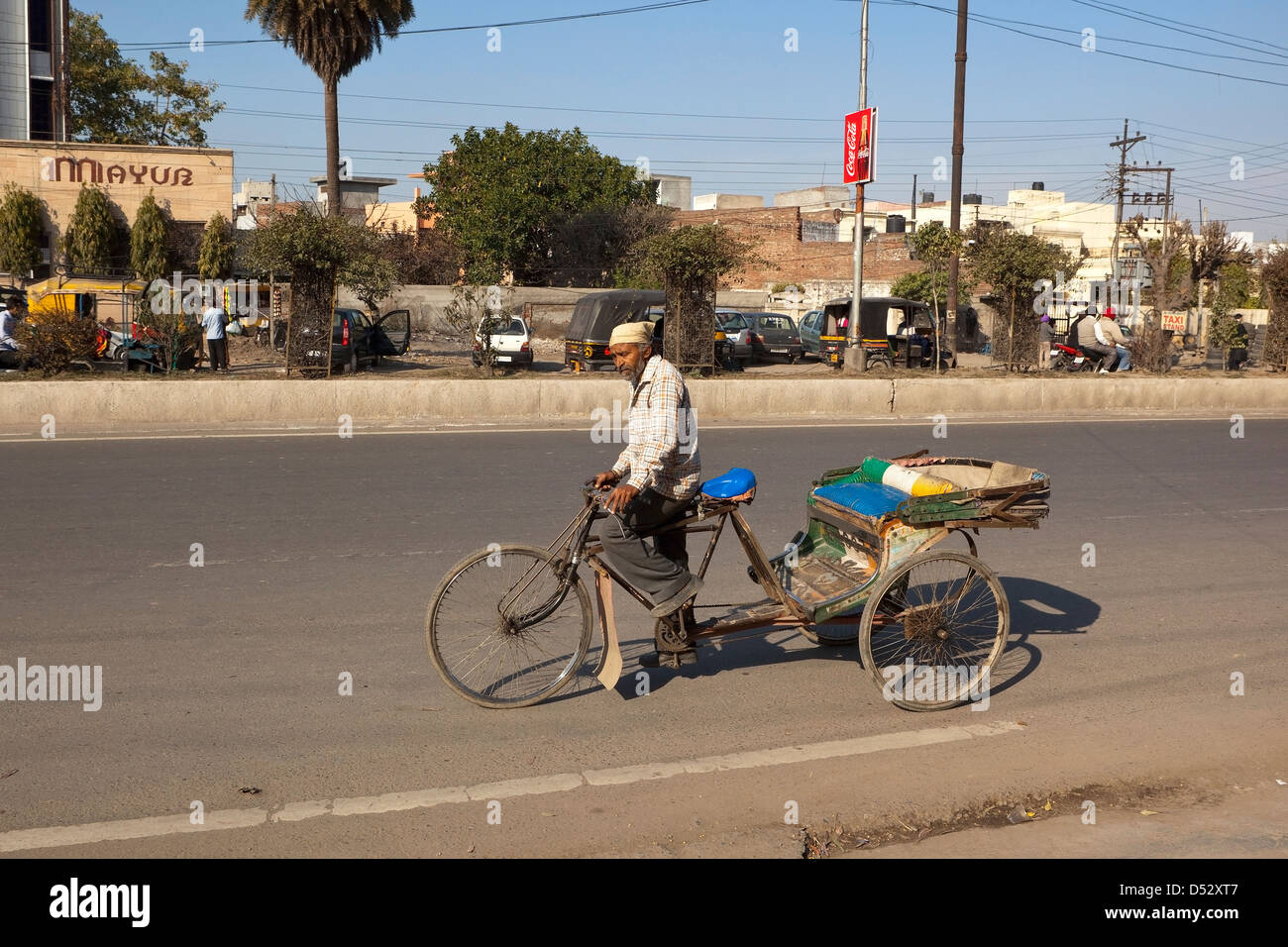 A Punjabi man with an empty cycle rickshaw riding along the streets of ...