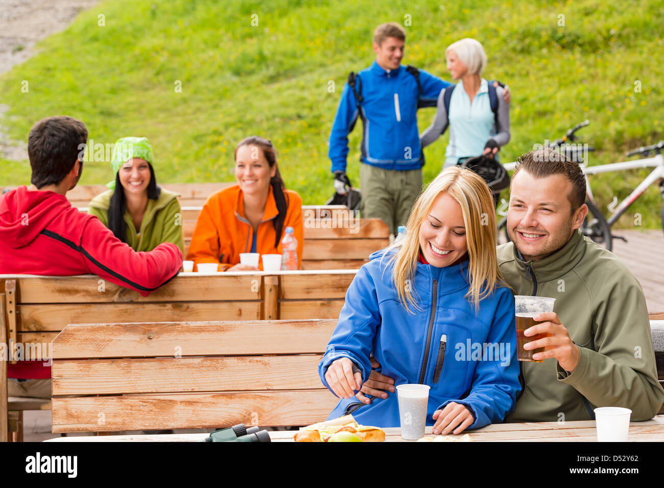 Cheerful people enjoying springtime weekend in rest area drinking beer ...