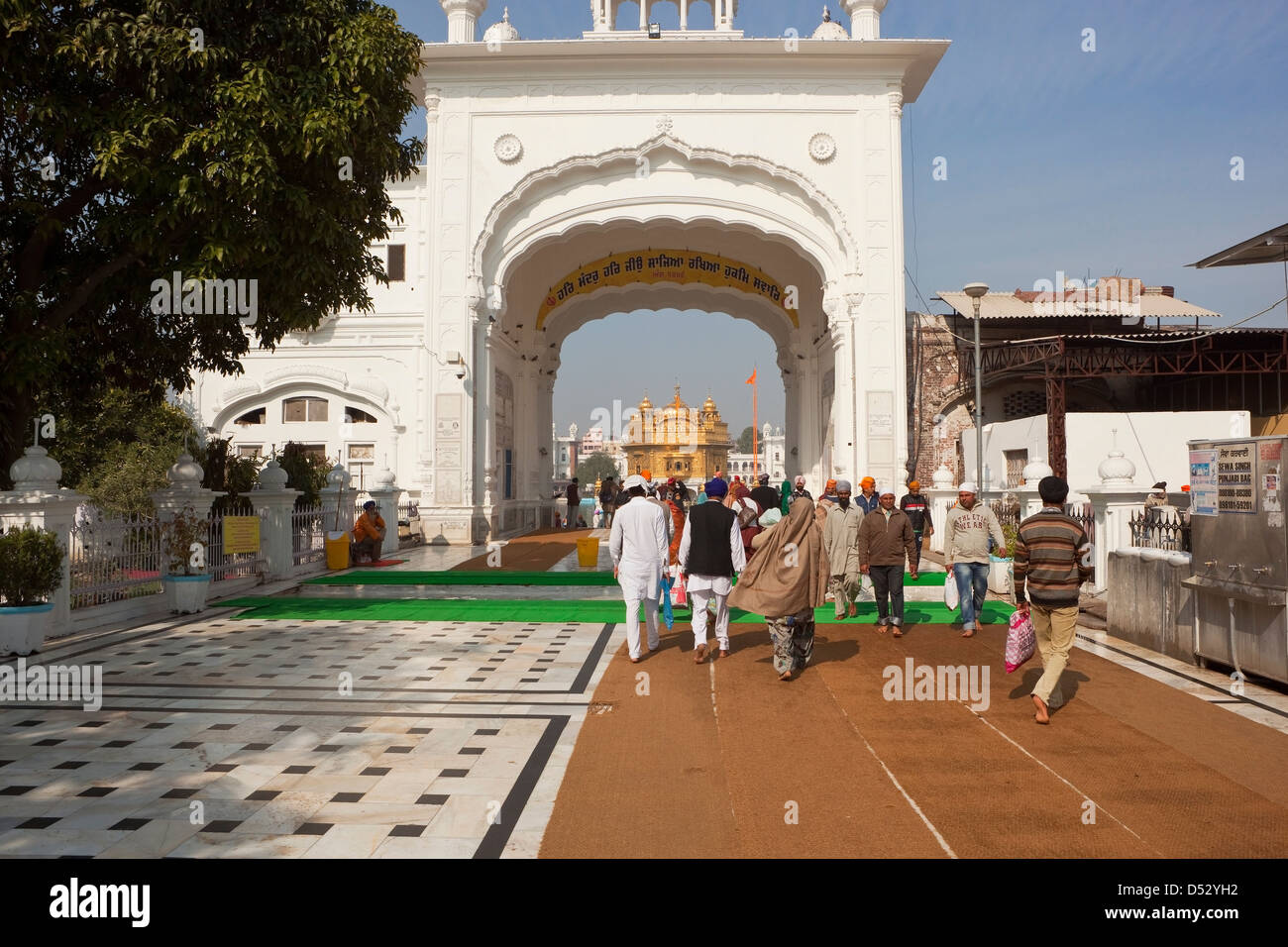 A busy scene inside the Golden Temple complex with temple guard ...